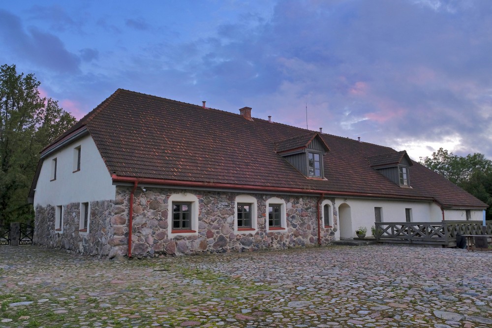 Seda watermill building with stone walls and red roof in a cobblestone ...
