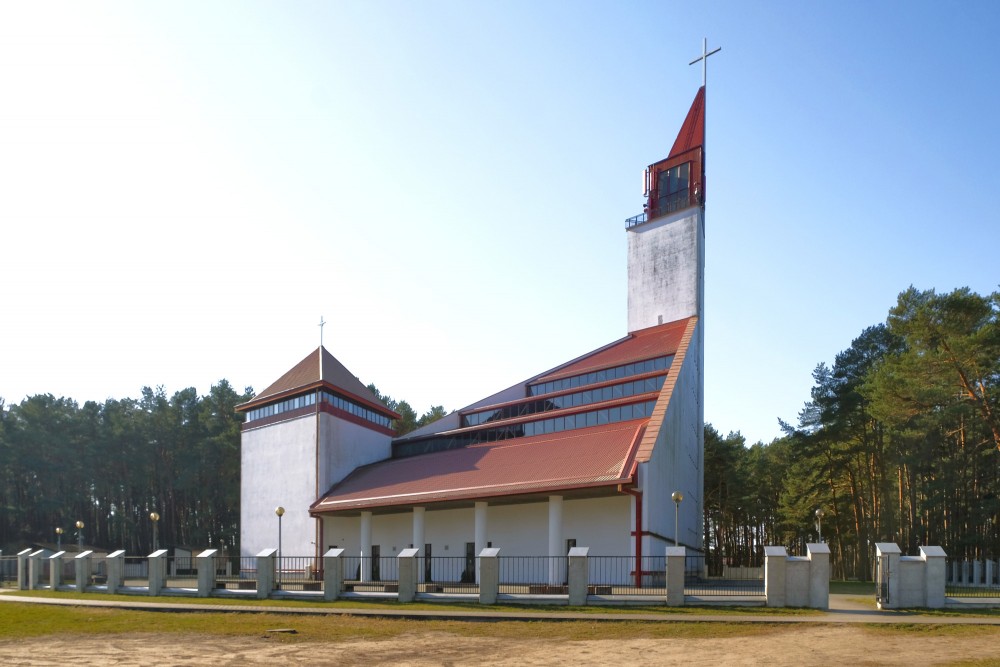 Šventoji Church of the Blessed Virgin Mary tower framed by pine trees ...