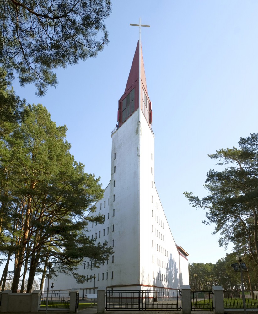 Šventoji Church of the Blessed Virgin Mary tower framed by pine trees ...