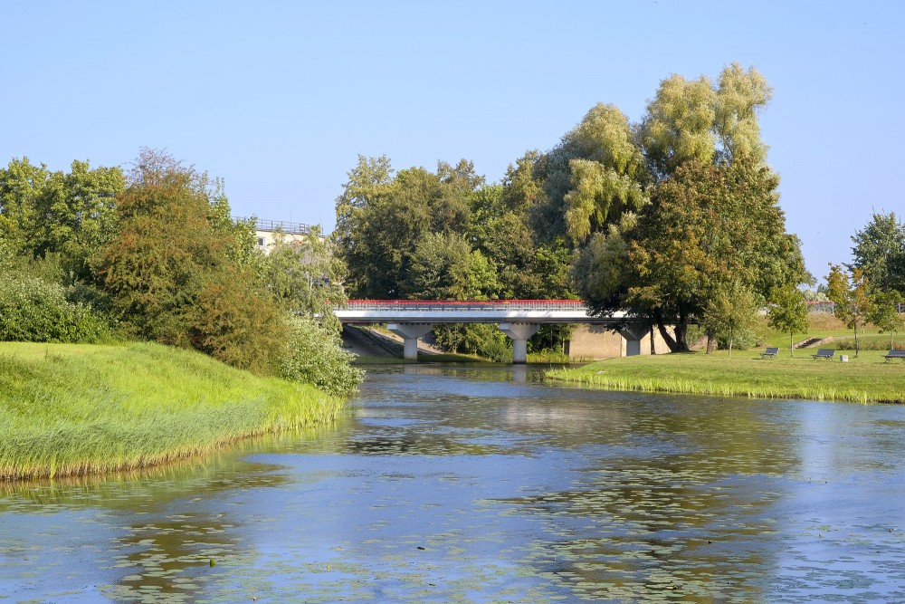 Bend of the Bārta River with tree-lined banks in a Skuodas city park ...