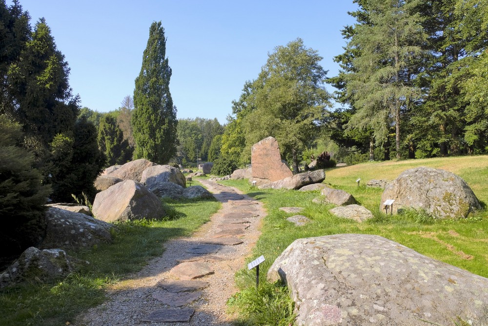 Metal dragon sculpture on a boulder in the stone park - redzet.lv