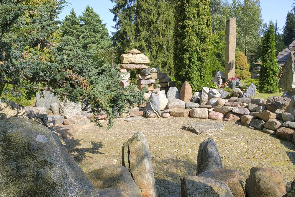 Stone garden courtyard with boulder wall and sculptural composition ...