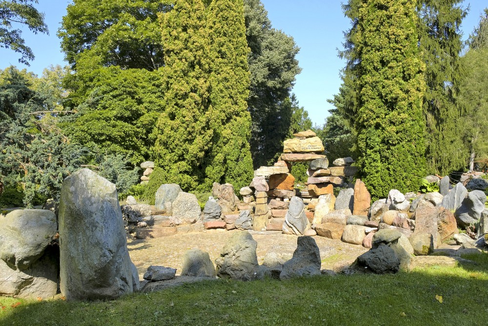 Rock composition with boulders and conifer backdrop in a sunny garden ...