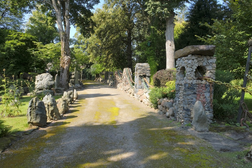 Stone garden courtyard with boulder wall and sculptural composition ...