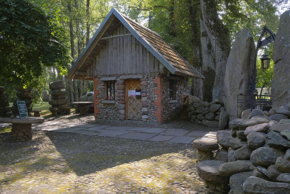 Rock composition with boulders and conifer backdrop in a sunny garden ...