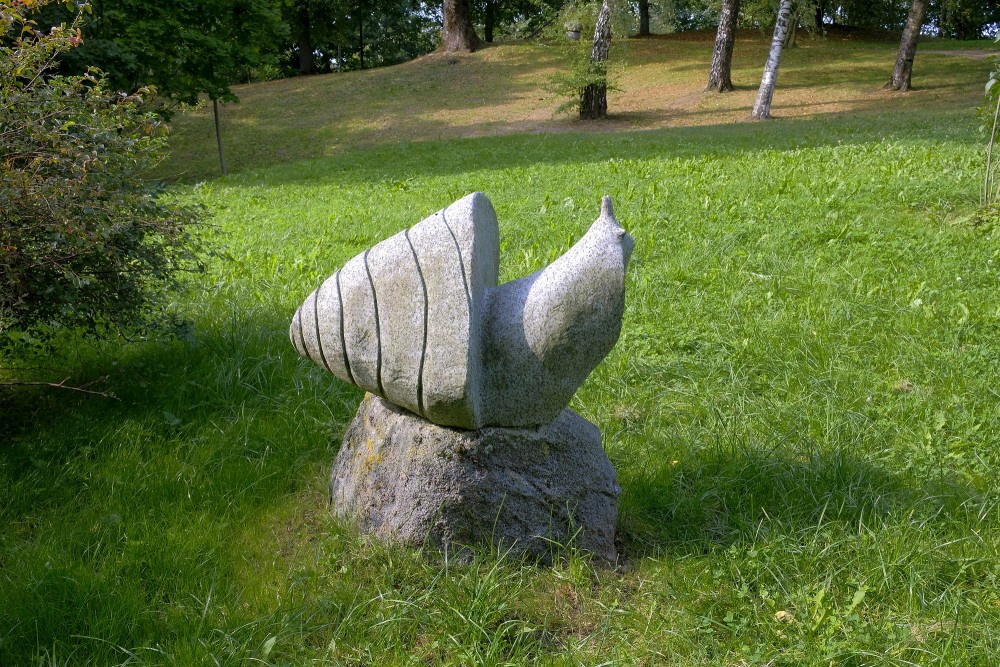 Winding paved path under tall trees in Salantai City Park - redzet.lv